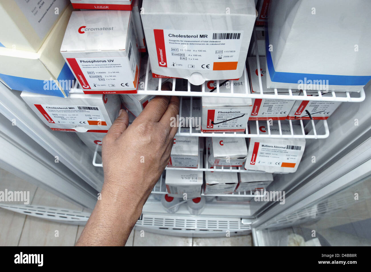 Laboratory reaches into refrigerator full of laboratory reagents Stock ...