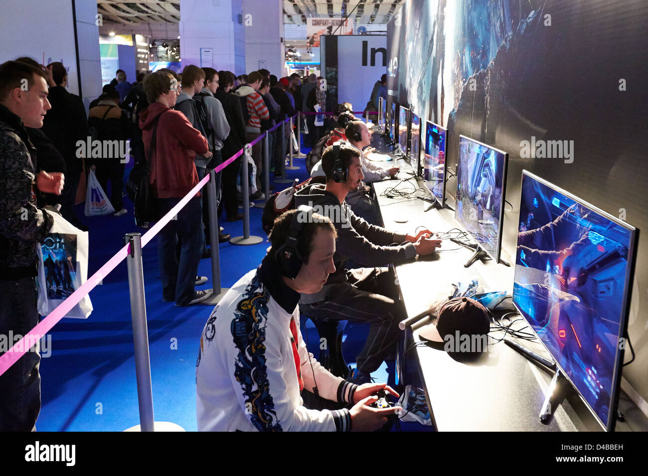 Visitors try out an unreleased computer game at the Eurogamer Expo in ...