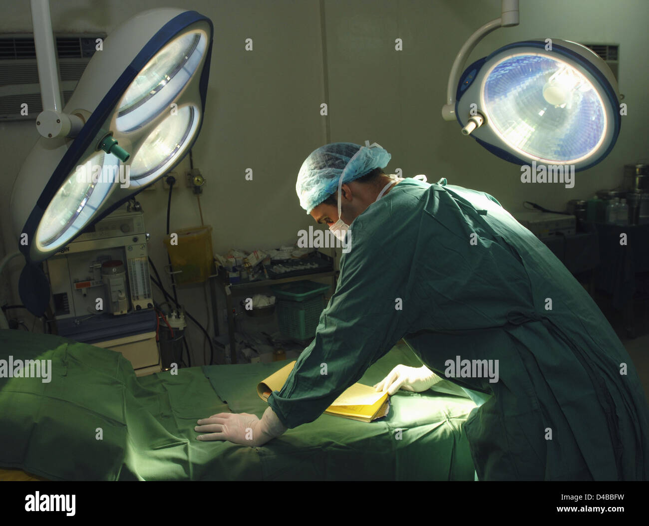 Hospital surgeon looking over patients notes before surgery Stock Photo ...