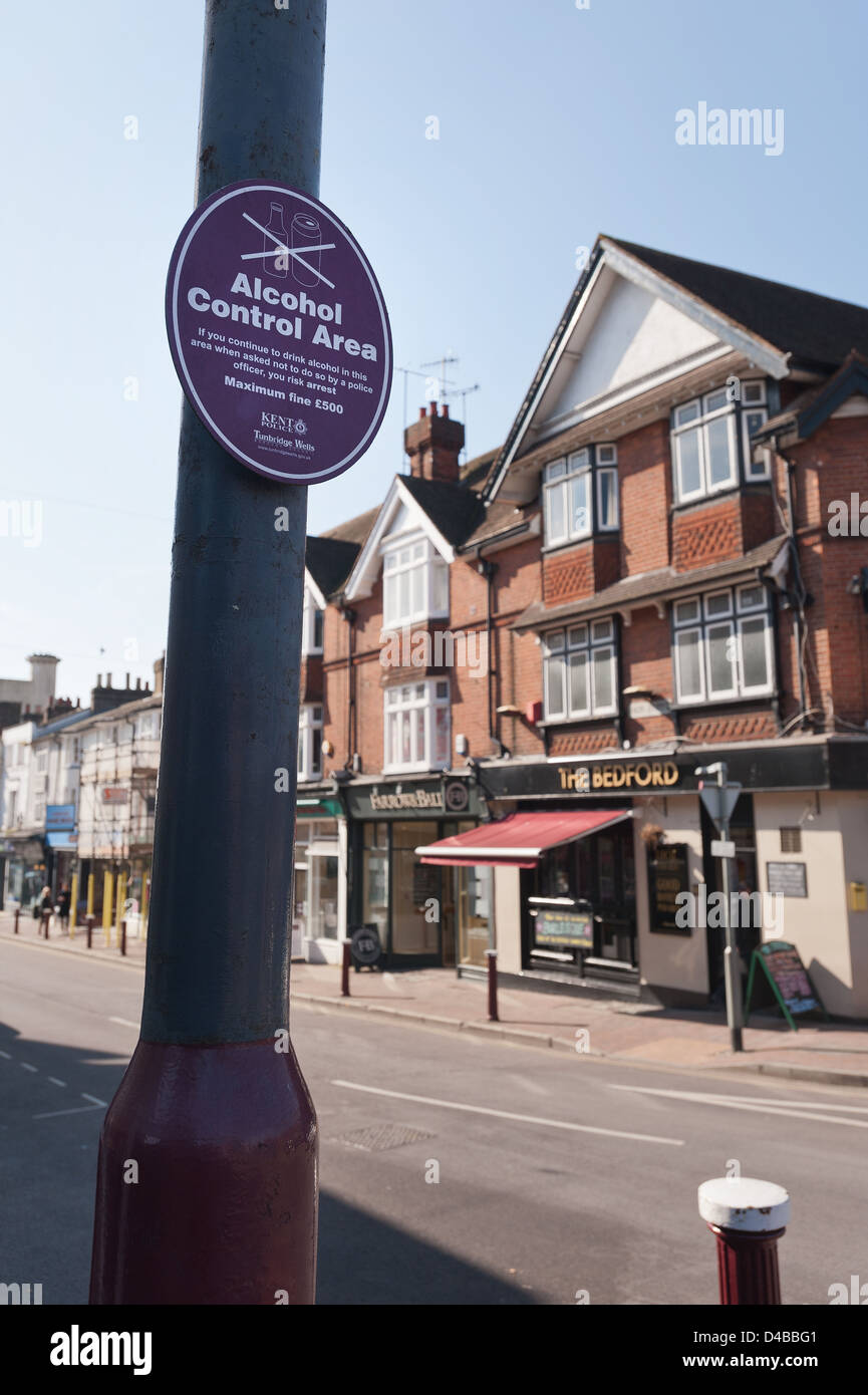 Alcohol control area fine £100 sign opposite a public house on the high ...