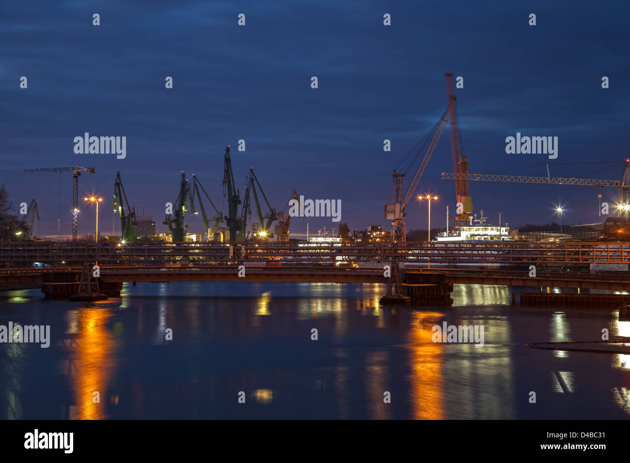 Big cranes and bridge at the shipyard at night Stock Photo - Alamy