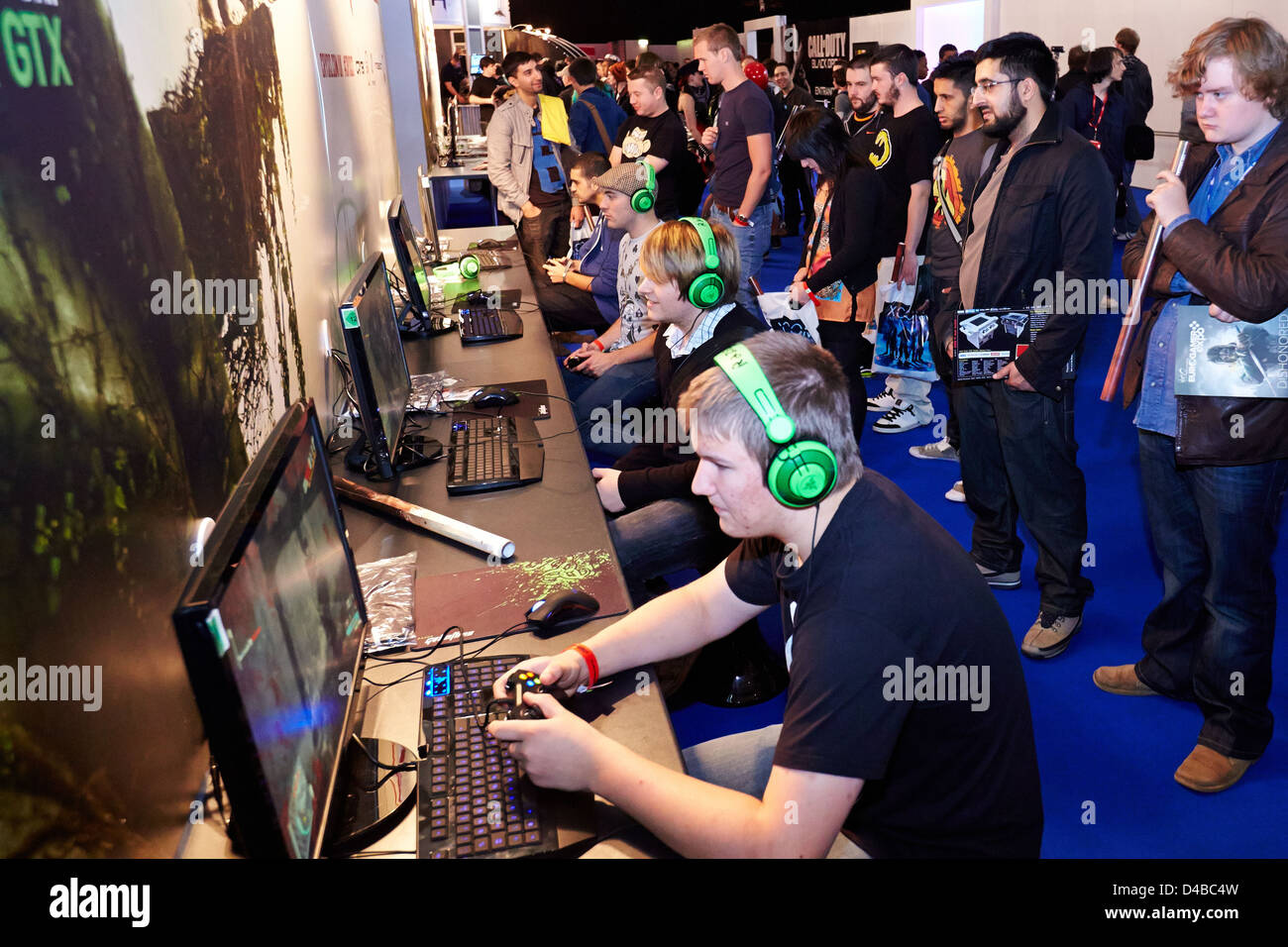 Visitors try out an unreleased computer game at the Eurogamer Expo in ...