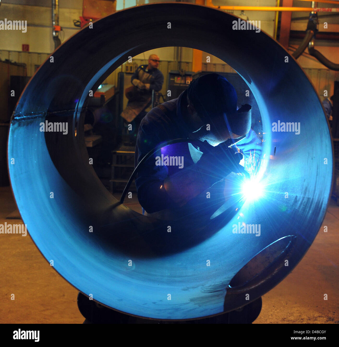 A welder works on a steel barrels at Huch Behaelterbau GmbH, container ...