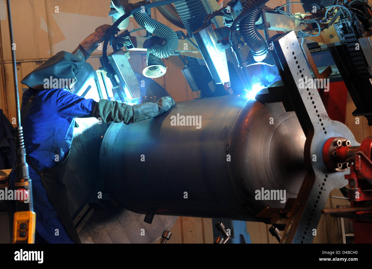 A welder works on a steel barrels at Huch Behaelterbau GmbH, container ...