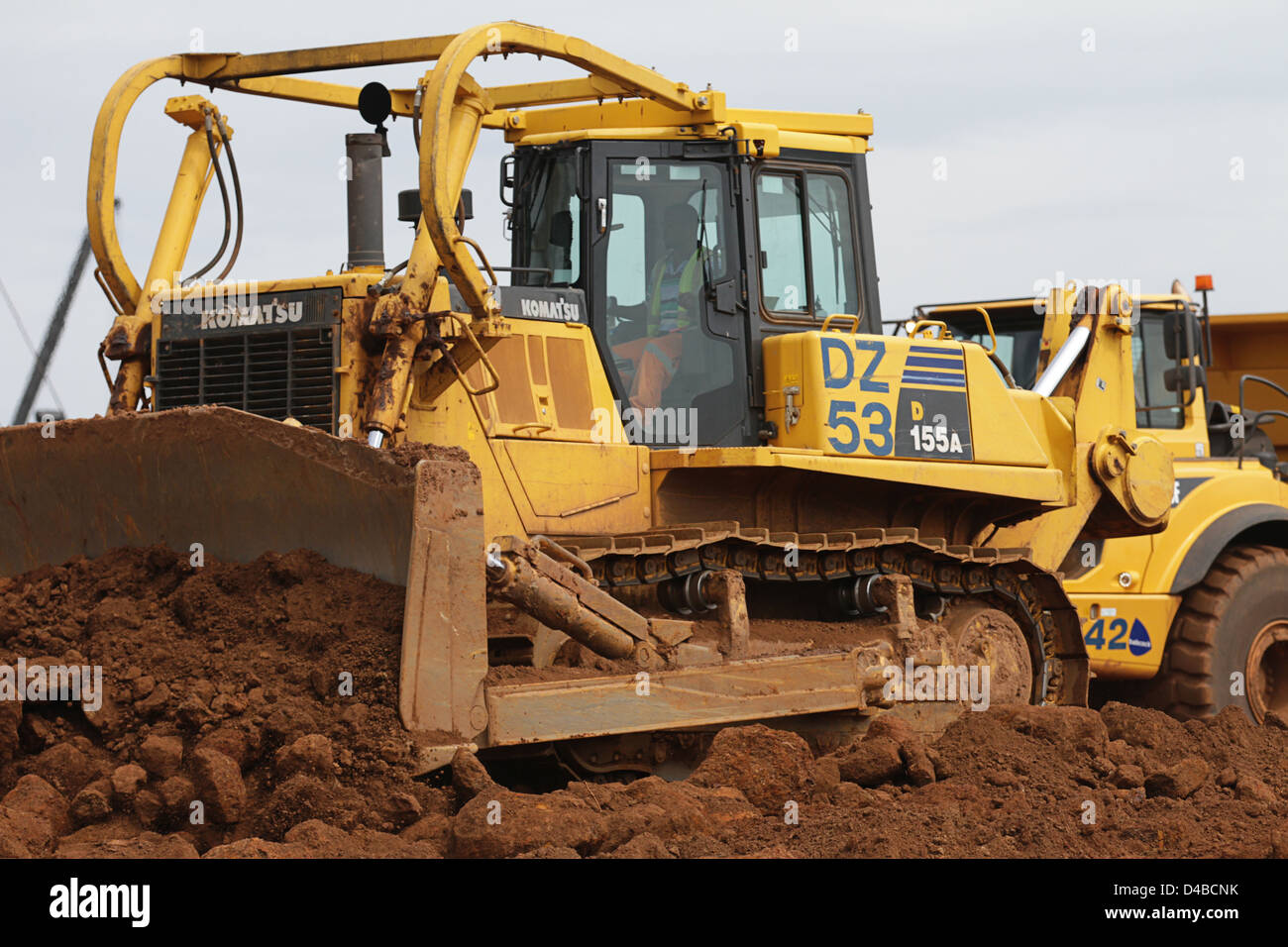 Yellow Komatsu bulldozer bulldozing rocks and sand at new Sentinel ...