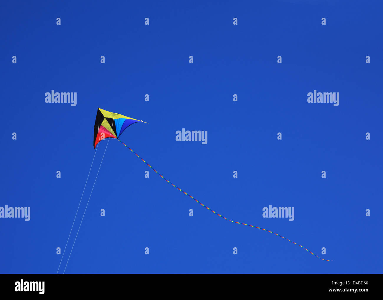 Kite flying in blue sky Stock Photo - Alamy