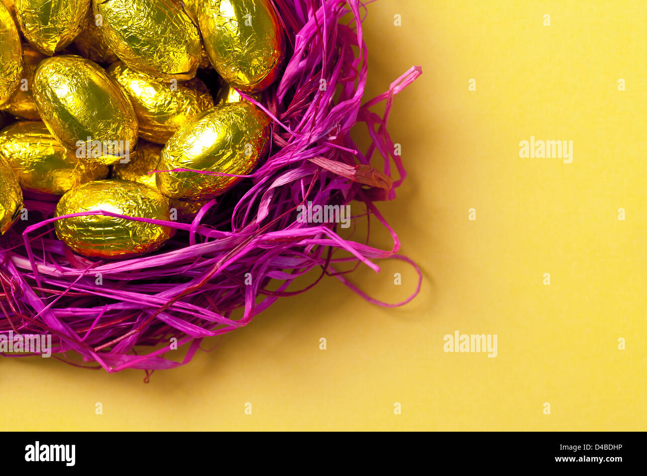 Chocolate easter eggs in pink nest. Holiday background. Top view. Macro ...