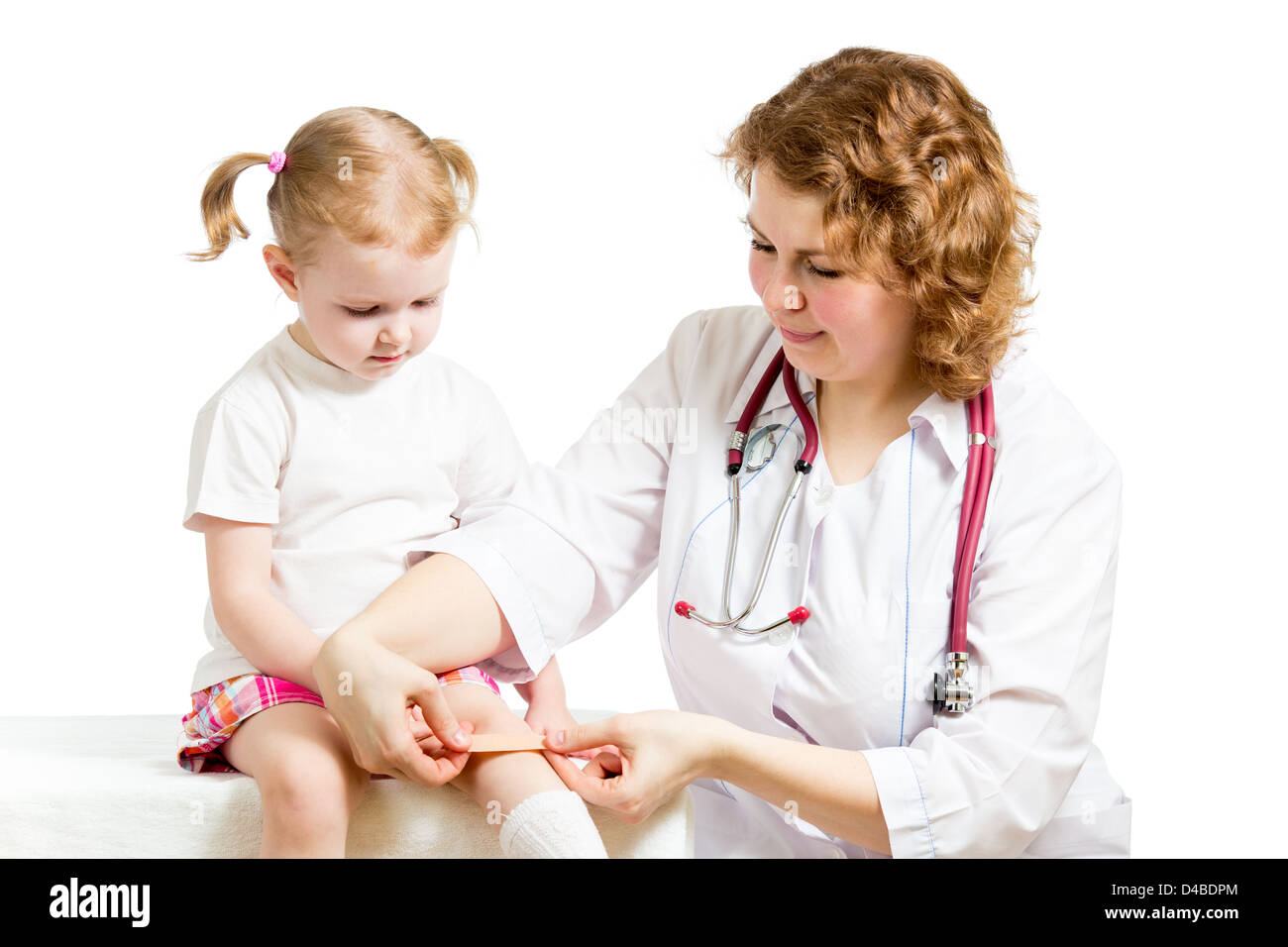 Girl with scratched knee. Doctor curing kid isolated on white Stock ...