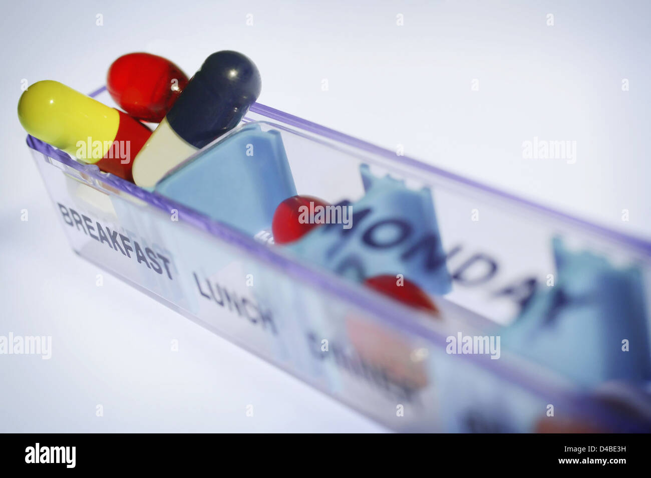 Daily doses pill box labeled with times of the day to remind the user ...