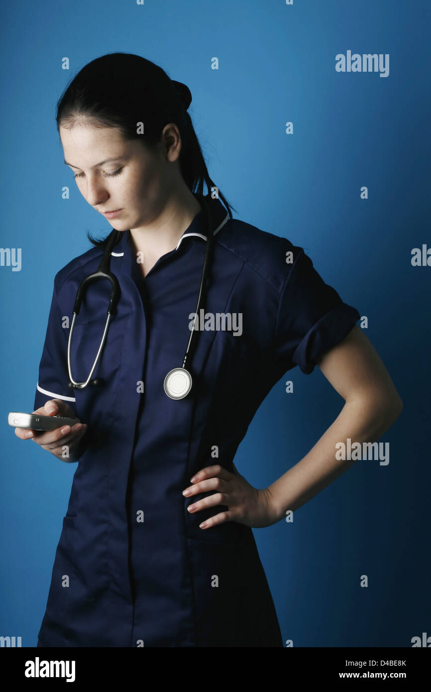Young nurse using her mobile telephone Stock Photo - Alamy