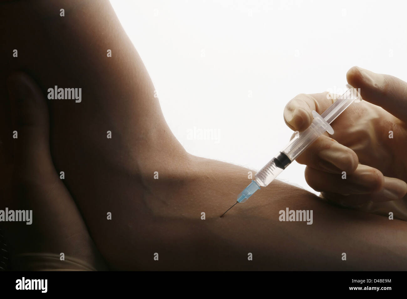 Injection in mans arm Stock Photo - Alamy