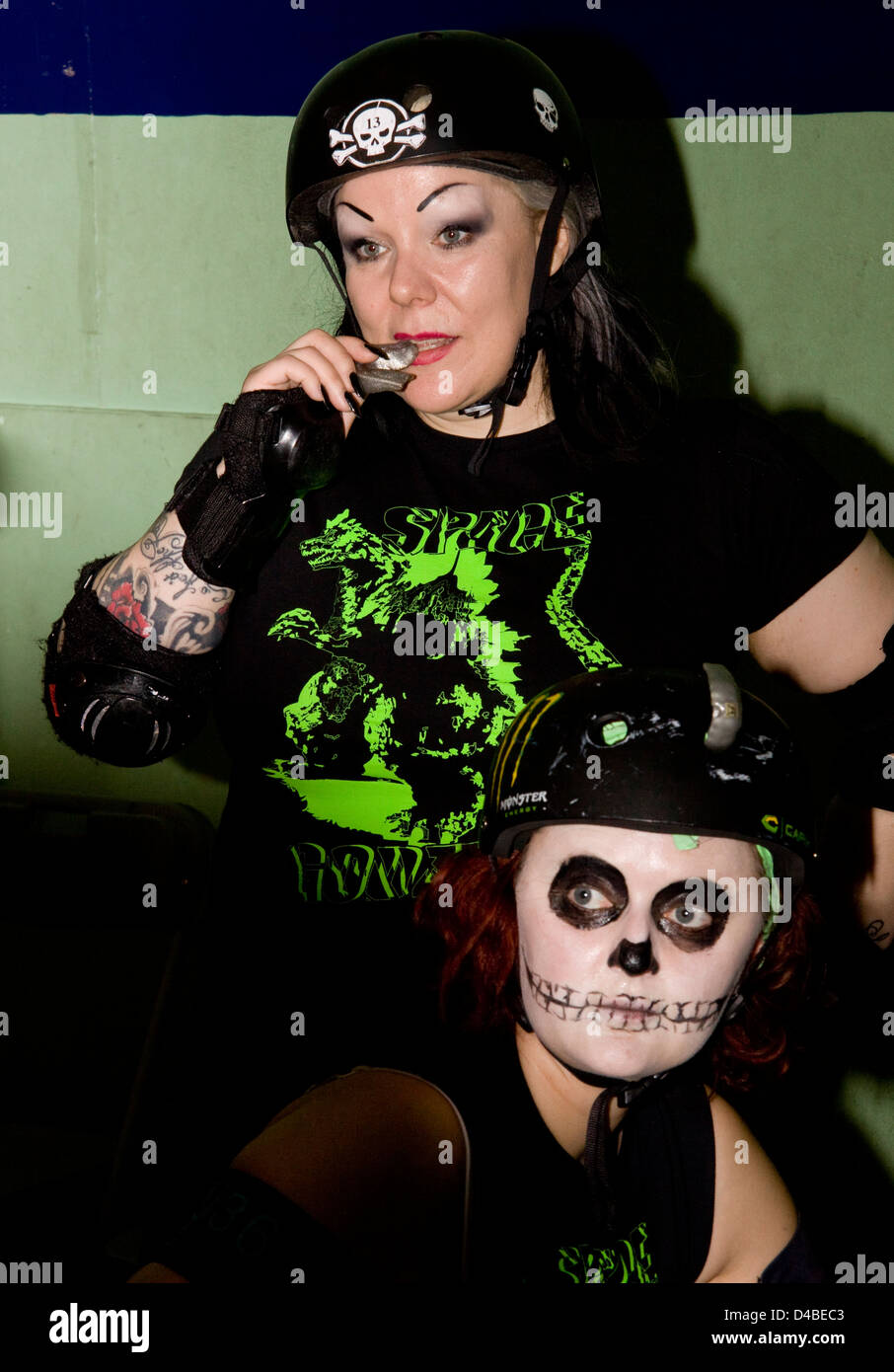 Roller derby girls, one in skull makeup and one in Goth make up Stock ...