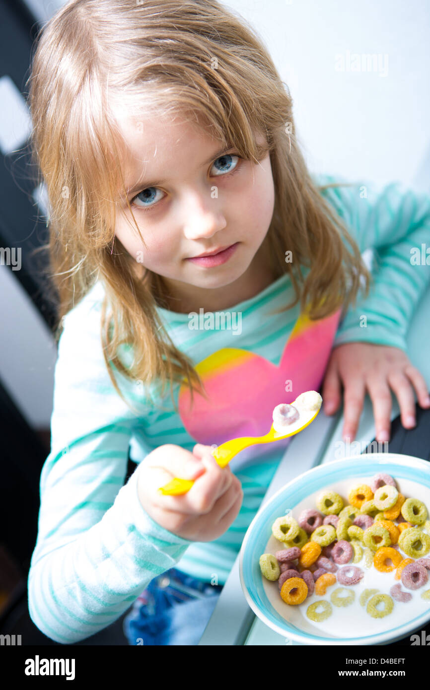 young girl eating cornflakes from the bowl Stock Photo - Alamy