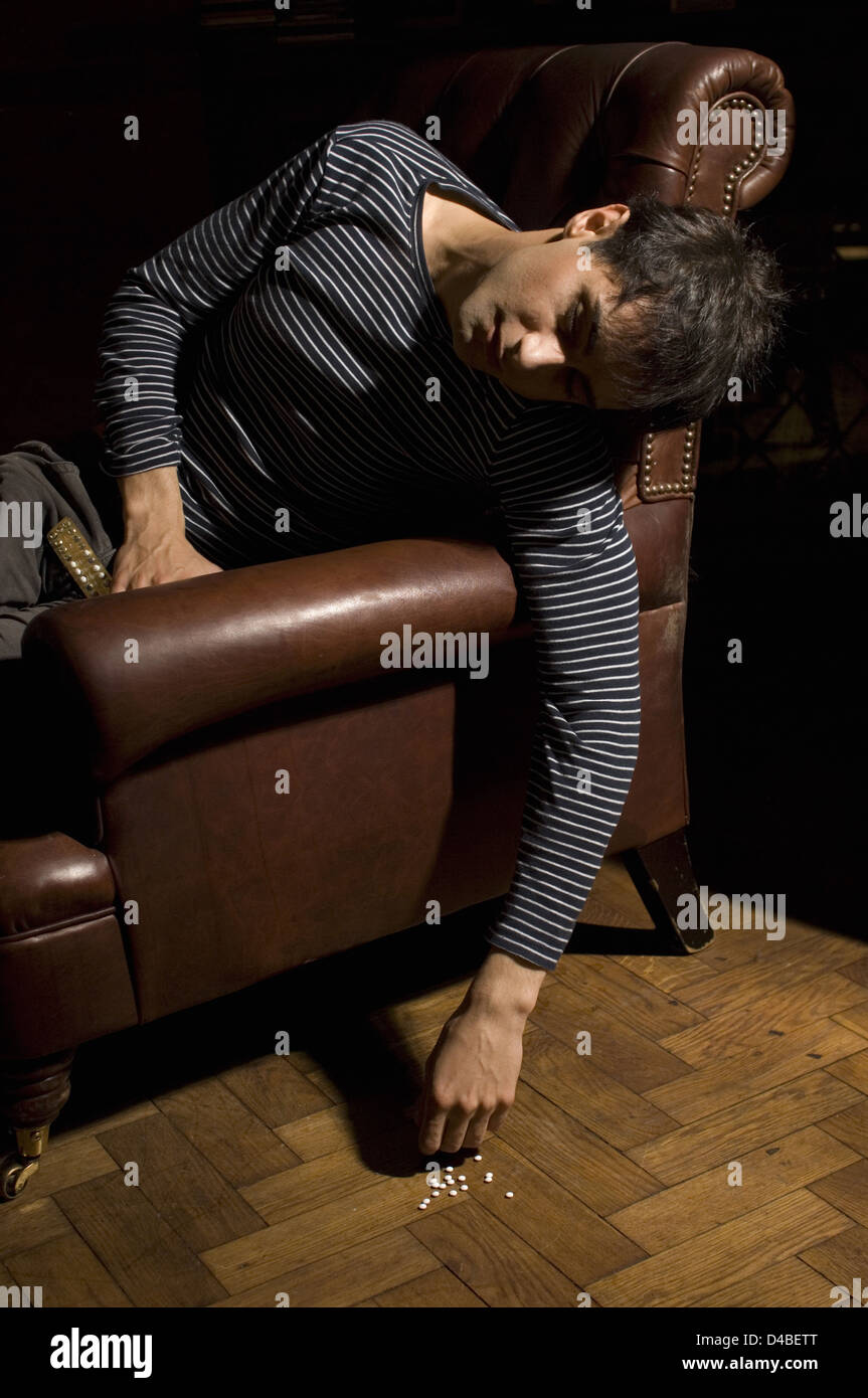 Man over-dosing on pills Stock Photo - Alamy