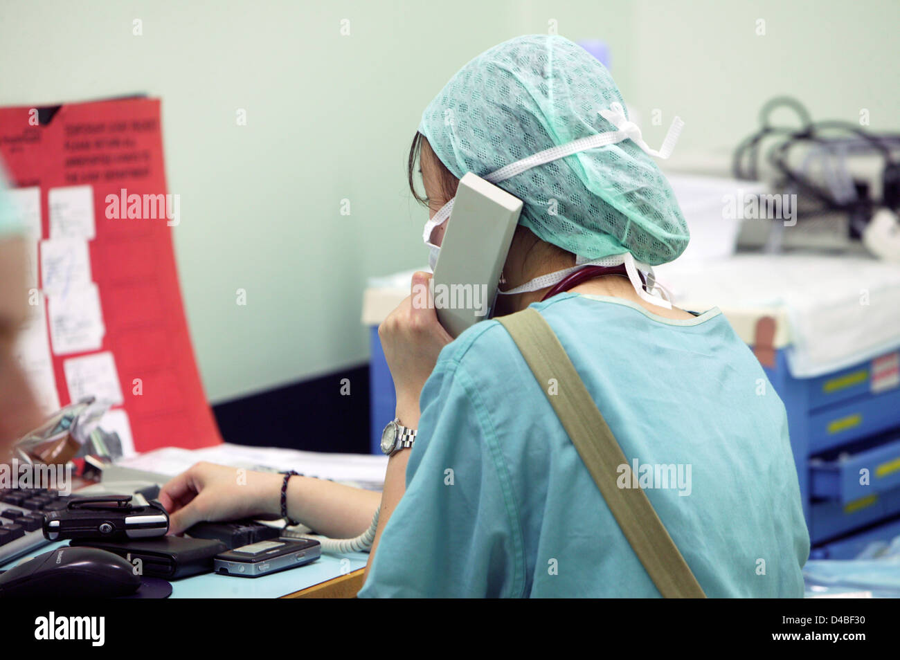 Surgical nurse speaking on telephone in surgical theatre. UK Stock ...