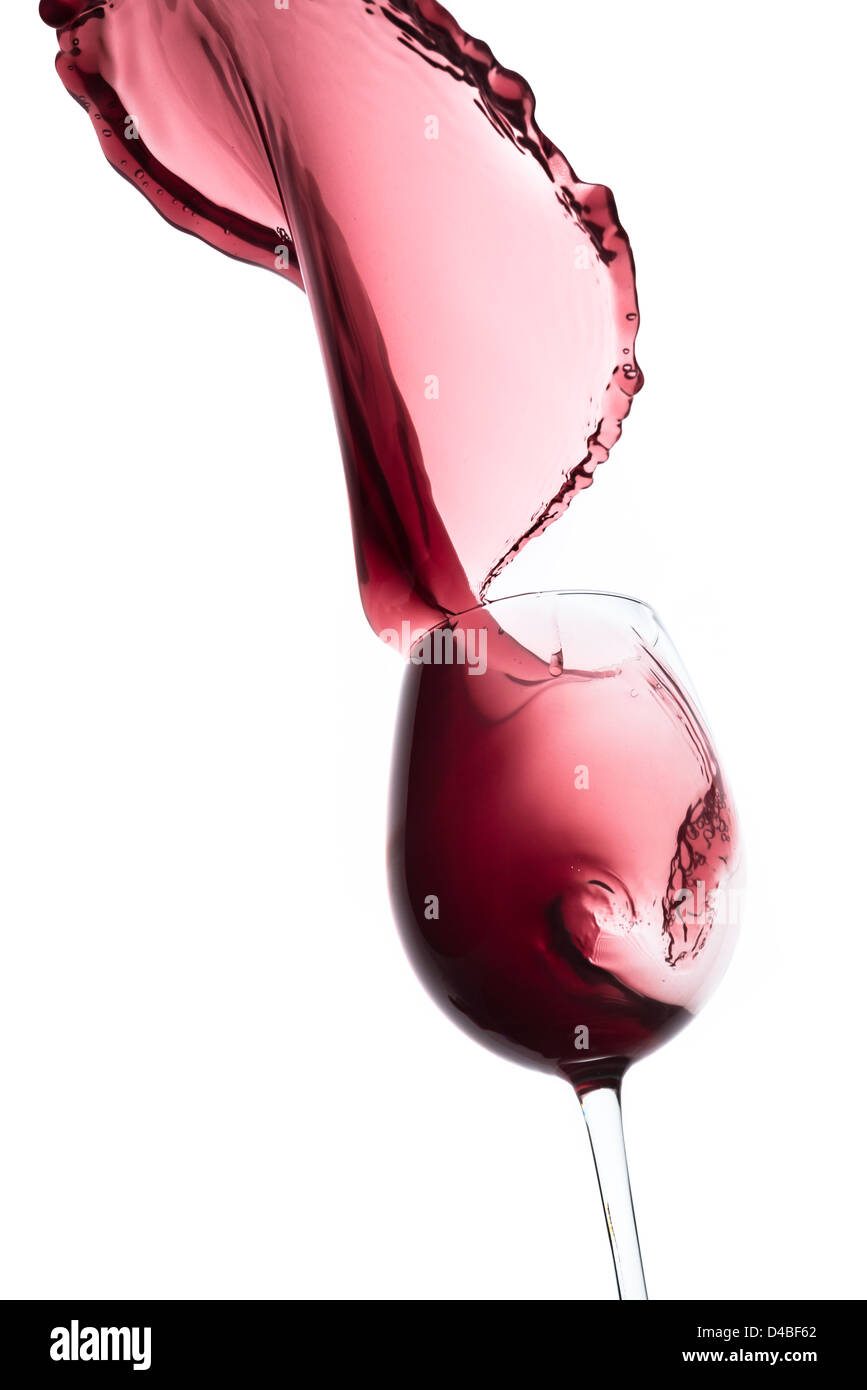 red wine splashing out of a glass, isolated on white Stock Photo - Alamy