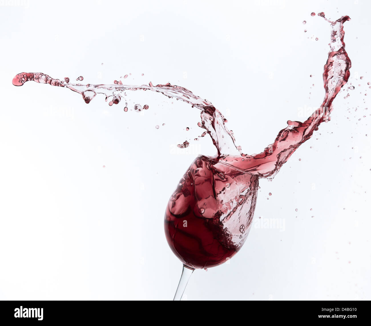 red wine splashing out of a glass, isolated on white Stock Photo - Alamy