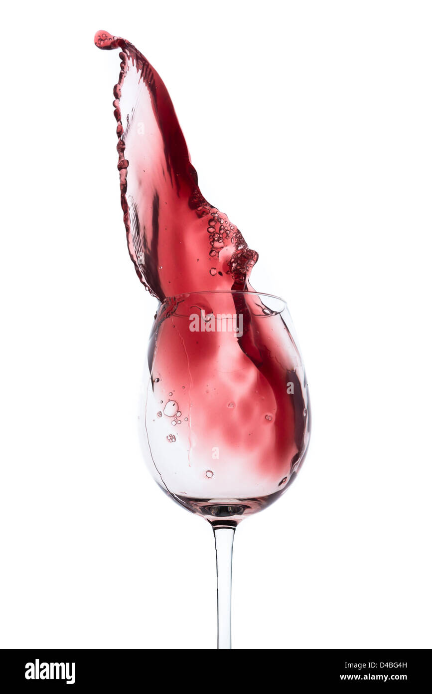 red wine splashing out of a glass, isolated on white Stock Photo - Alamy