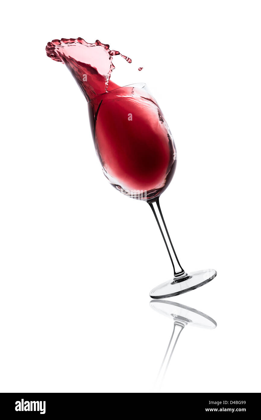 red wine splashing out of a glass, isolated on white Stock Photo - Alamy