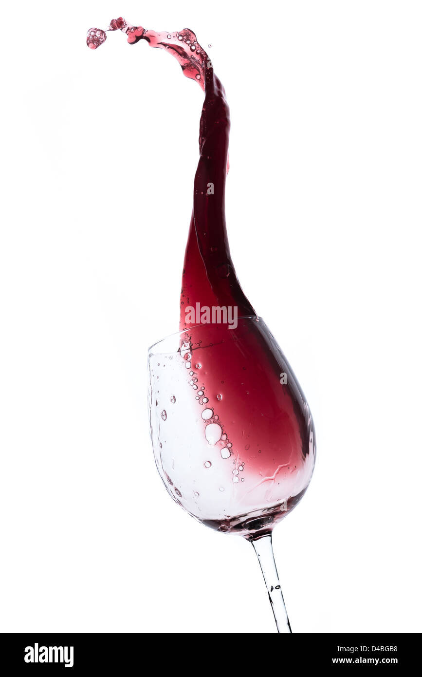 red wine splashing out of a glass, isolated on white Stock Photo - Alamy