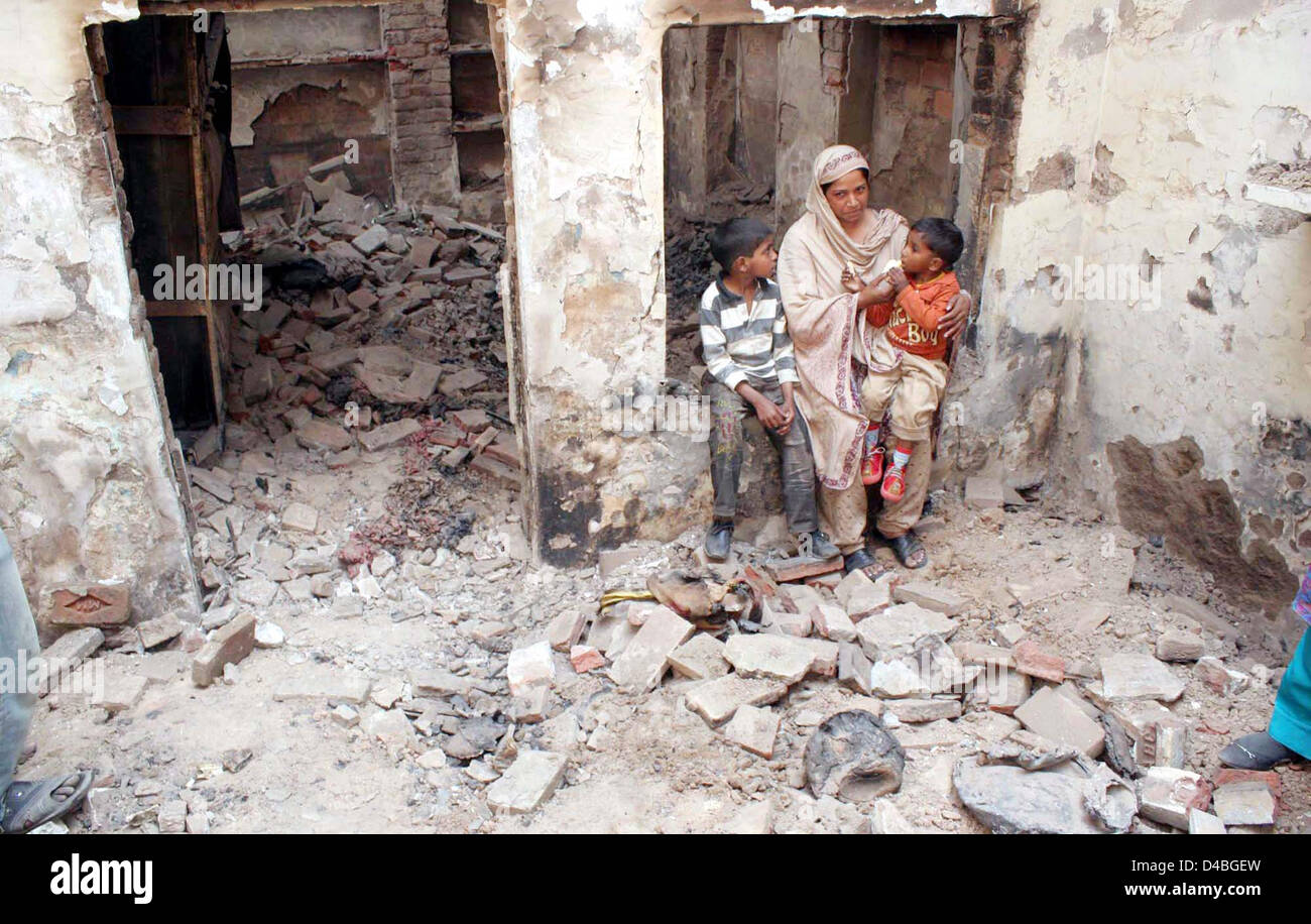 Woman of Christian Community sits worried along with her children at ...