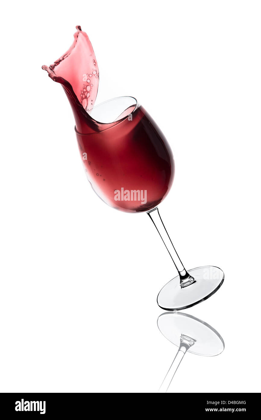 red wine splashing out of a glass, isolated on white Stock Photo - Alamy