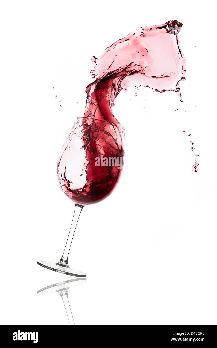 red wine splashing out of a glass, isolated on white Stock Photo - Alamy