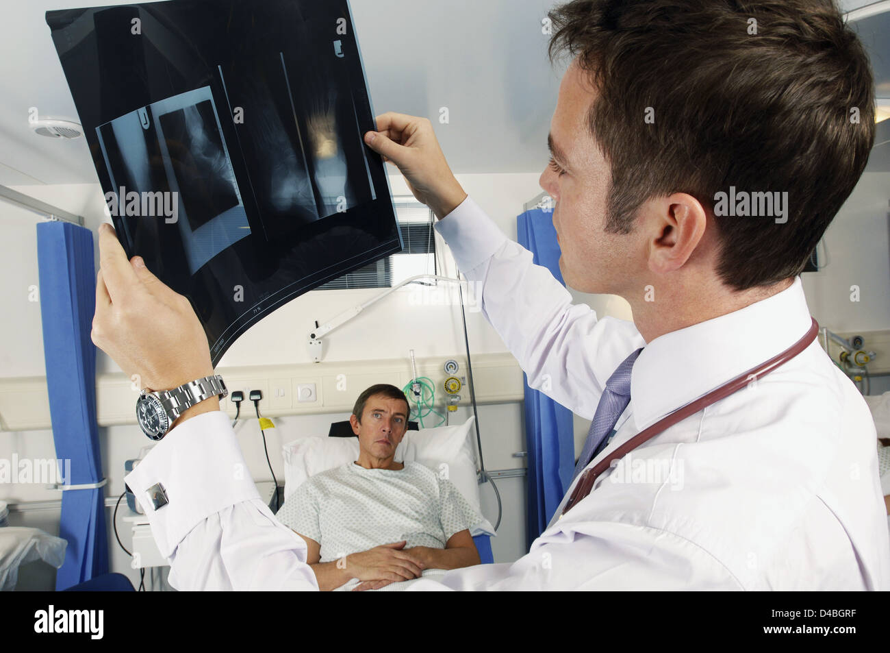 doctor on his hospital ward round examines patients x-ray Stock Photo ...