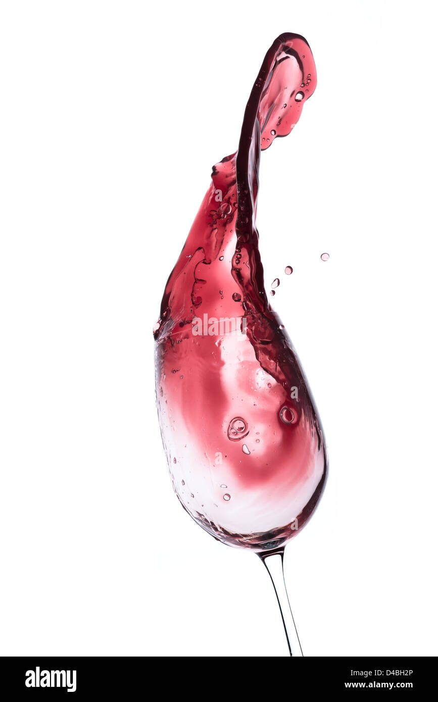 red wine splashing out of a glass, isolated on white Stock Photo - Alamy