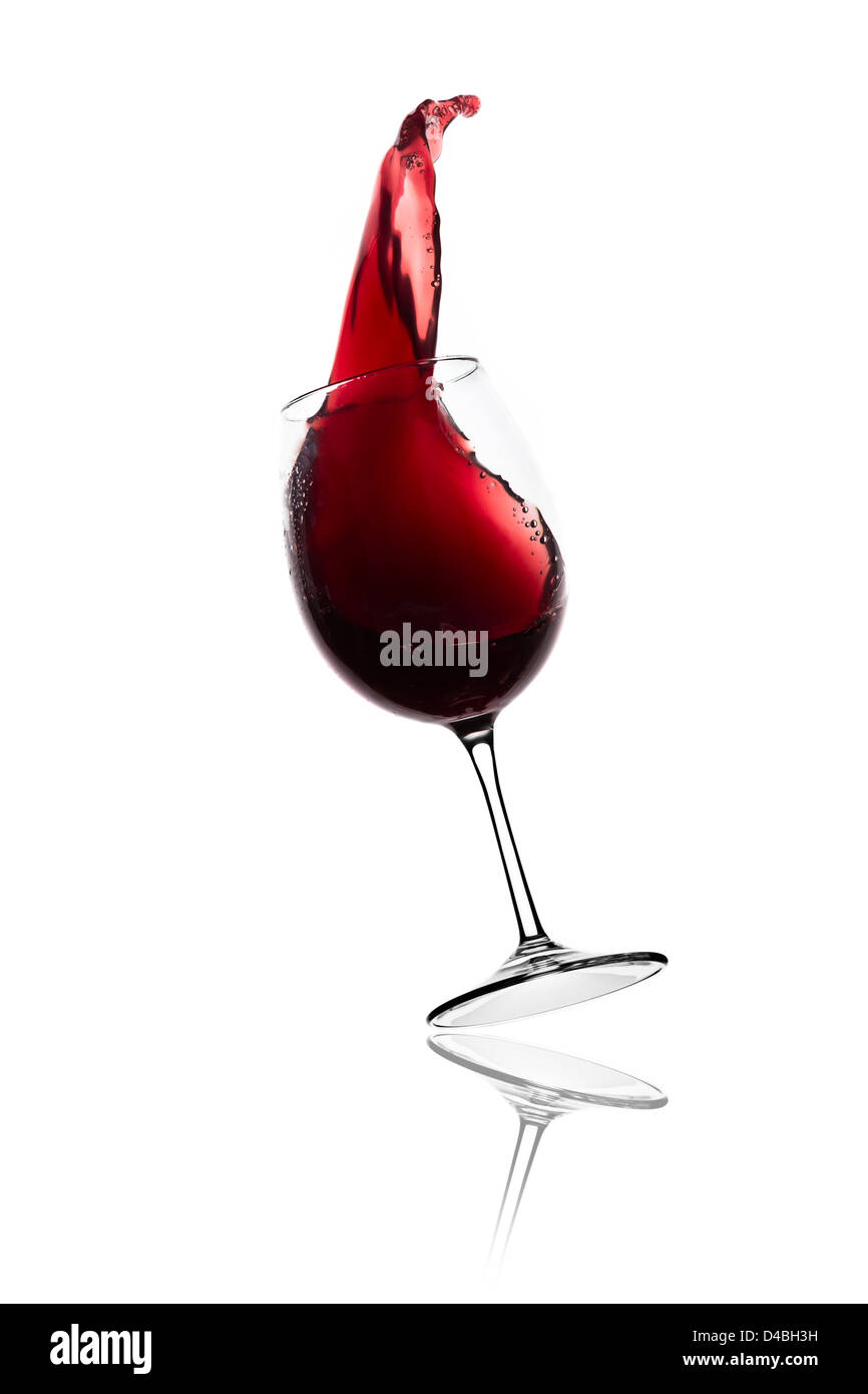 red wine splashing out of a glass, isolated on white Stock Photo - Alamy