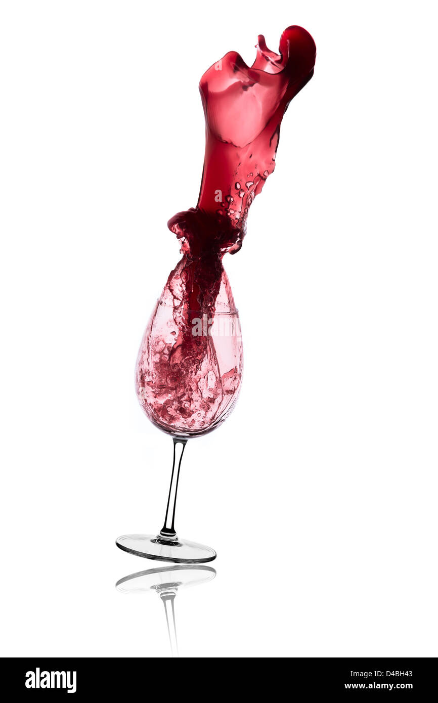 red wine splashing out of a glass, isolated on white Stock Photo - Alamy