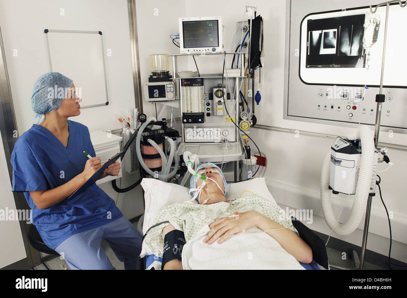 Female anesthetist monitoring patients condition hi-res stock ...