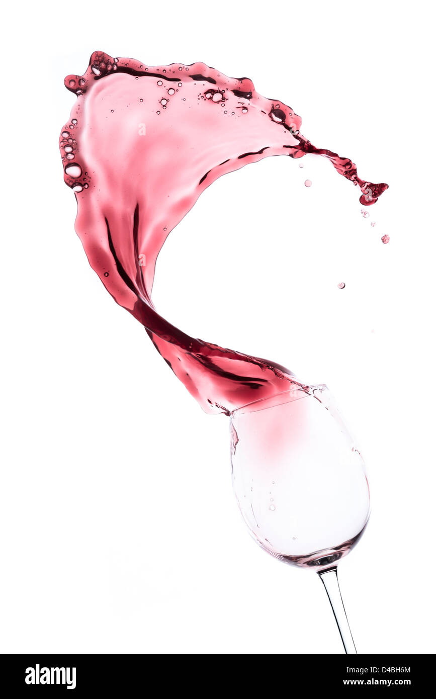 red wine splashing out of a glass, isolated on white Stock Photo - Alamy