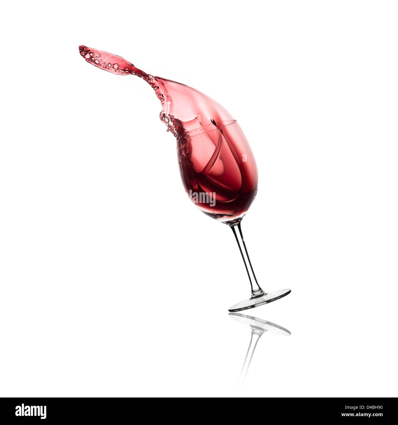 red wine splashing out of a glass, isolated on white Stock Photo - Alamy