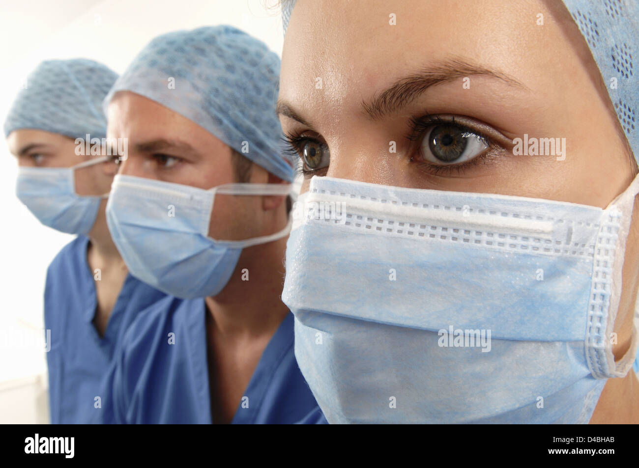 Close up of male doctor, male anesthetist, and female nurse wearing ...