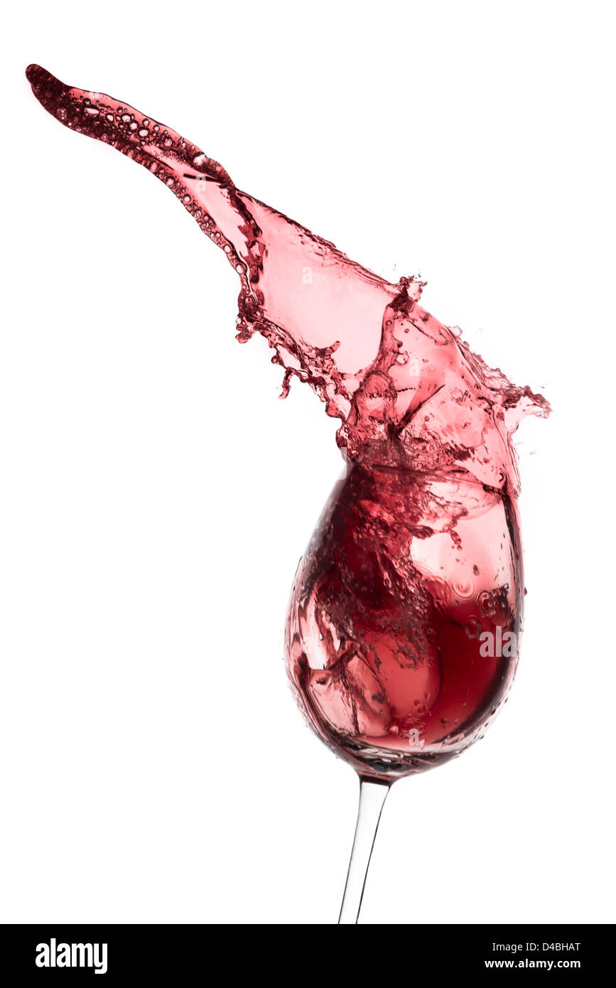 red wine splashing out of a glass, isolated on white Stock Photo - Alamy