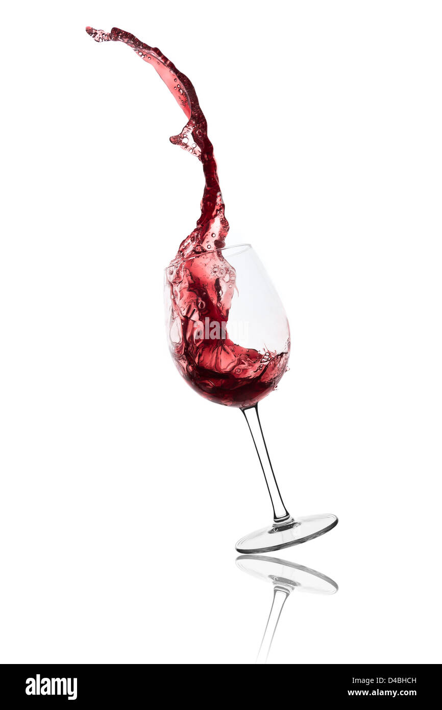 red wine splashing out of a glass, isolated on white Stock Photo - Alamy