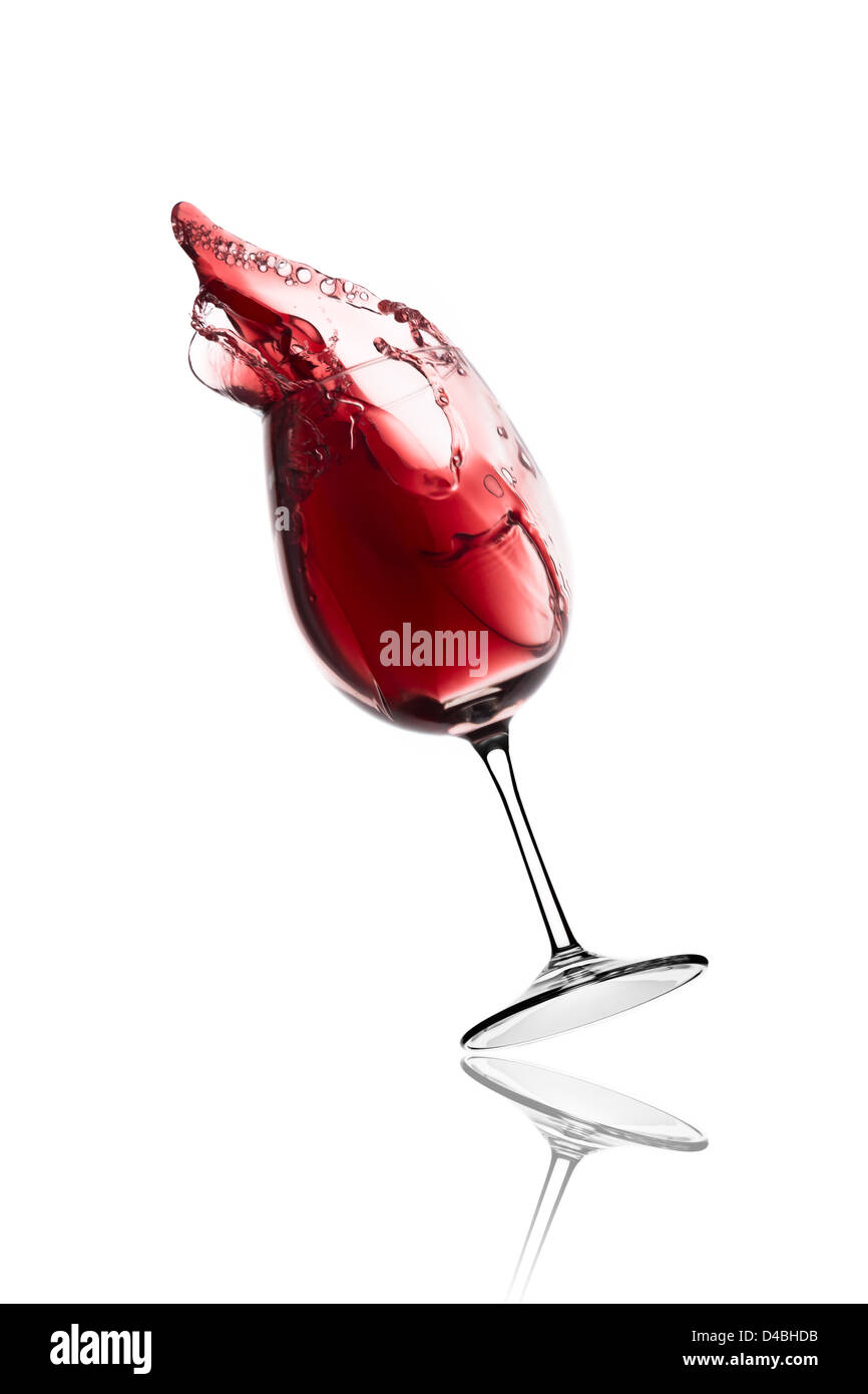red wine splashing out of a glass, isolated on white Stock Photo - Alamy