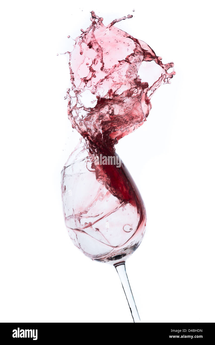 red wine splashing out of a glass, isolated on white Stock Photo - Alamy
