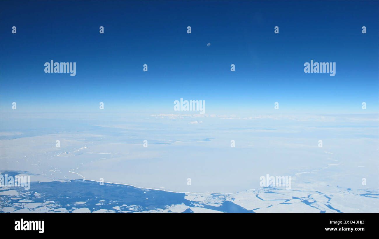 A view of the Moon rises over Antarctica, with the frozen ice shelf in ...