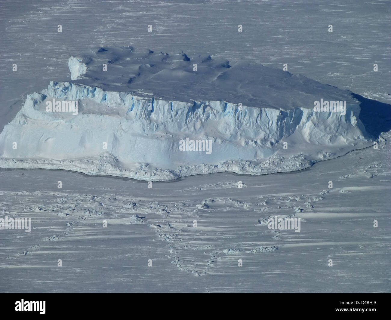An iceberg is trapped within the sea ice near Antarctica, part of the ...