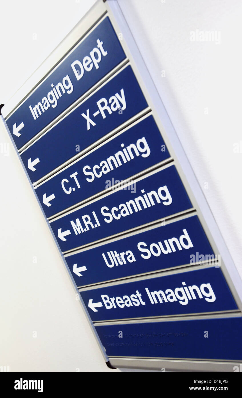 Blue hospital sign against white background directing visitors to ...