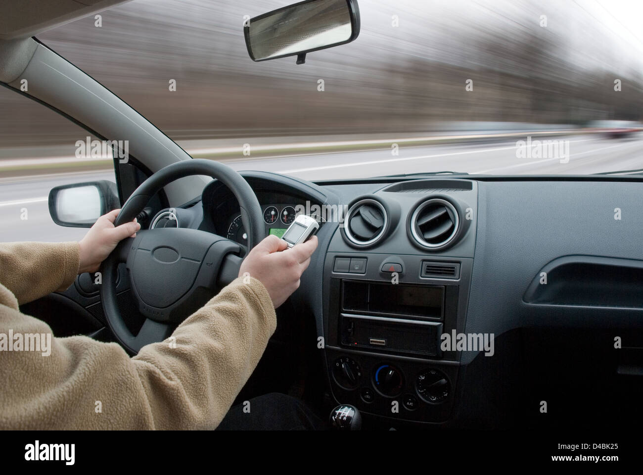 Driver using cell phone in car, blurred motion Stock Photo - Alamy