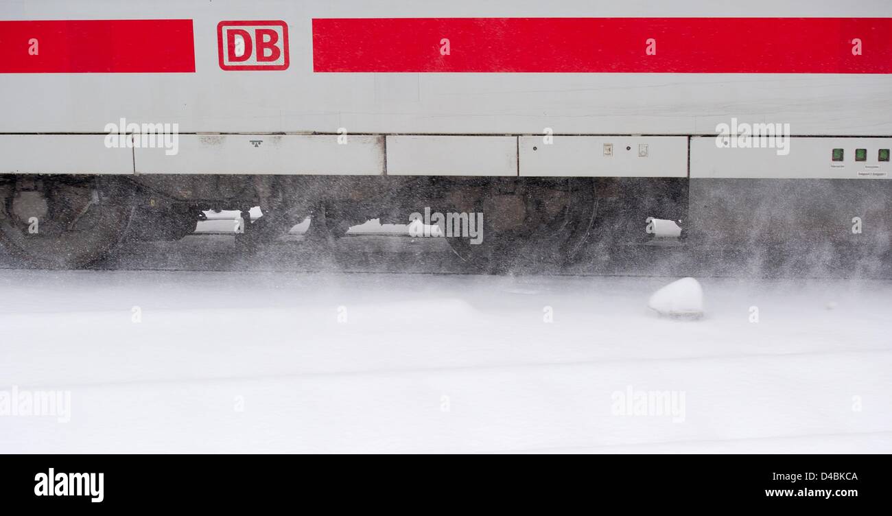 A Deutsche Bahn (DB) train pulls into central station in the heavy snow ...