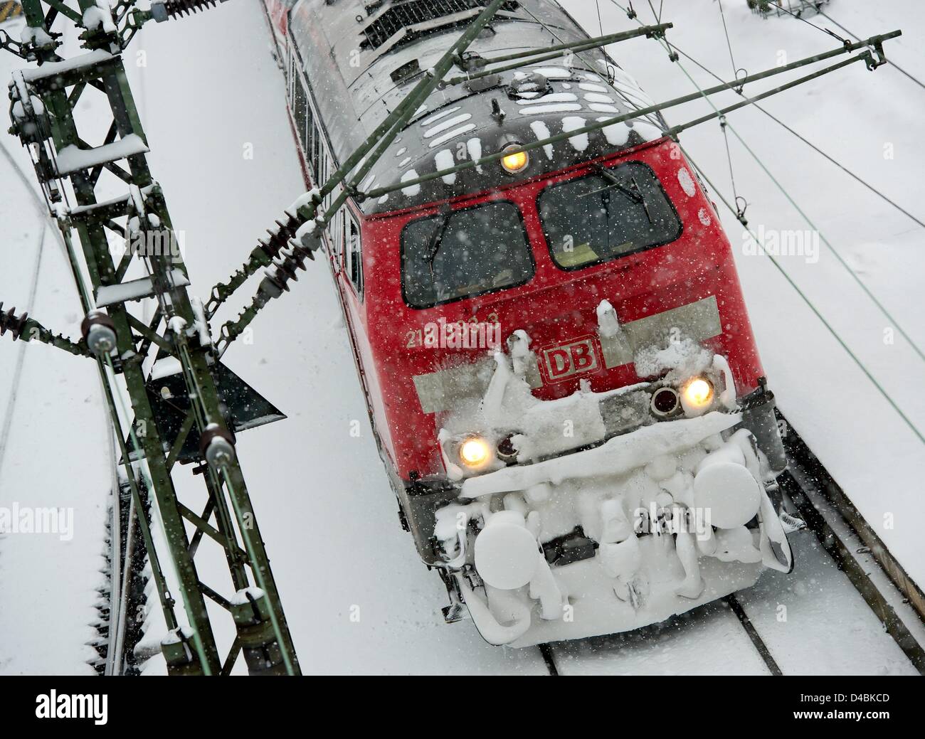 A Deutsche Bahn (DB) train pulls into central station in the heavy snow ...