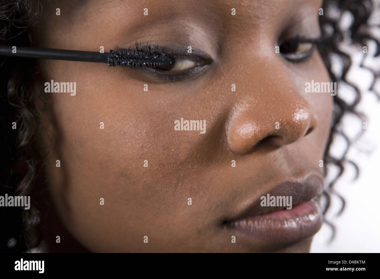 Young woman applying mascara Stock Photo - Alamy