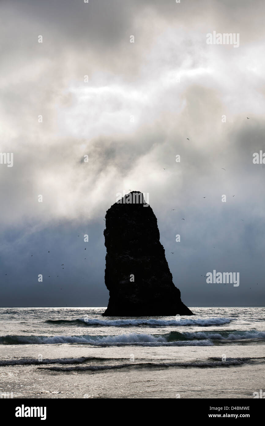 Rock formation in dramatic light, Cannon Beach, Oregon, USA Stock Photo ...