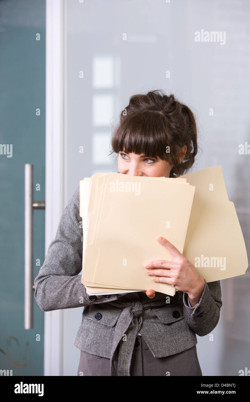 Business woman holding legal documents in modern office Stock Photo - Alamy