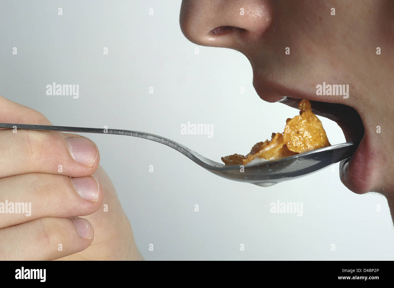 Teenage boy eating cornflakes, close-up Stock Photo - Alamy