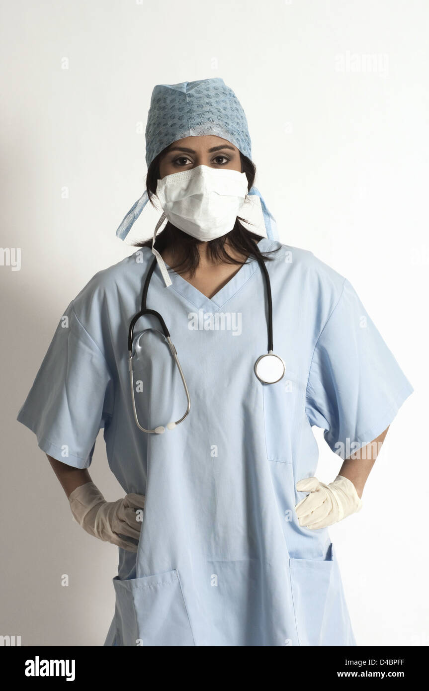 Studio portrait of female surgeon wearing hygiene mask and hat Stock ...